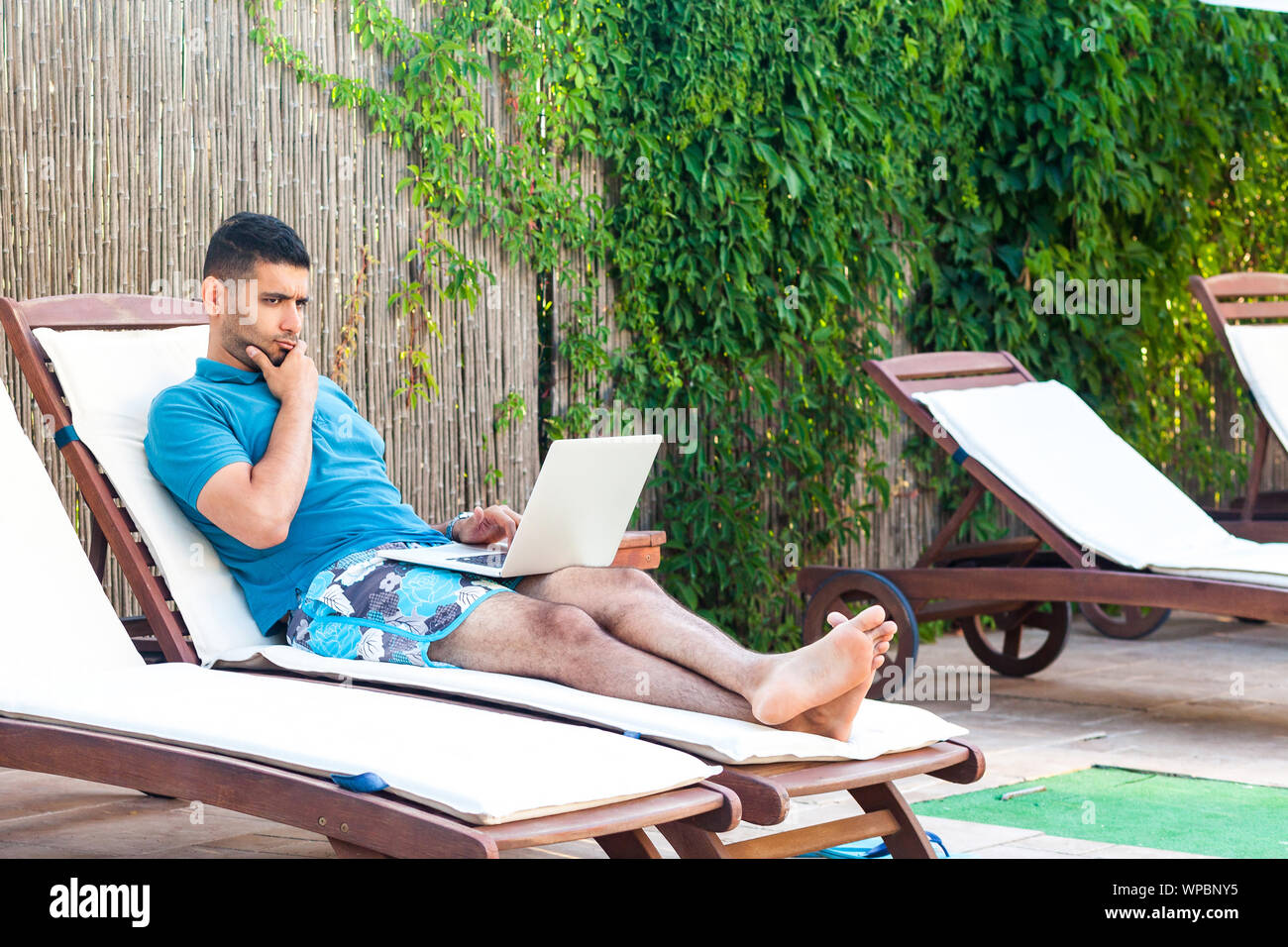 Portrait man lying on chair hi-res stock photography and images - Alamy