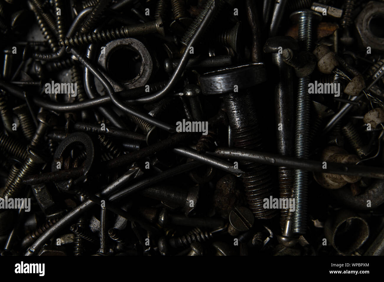 Range Rusty old screws bolts nuts. Grunge metal Hardware details dark ...