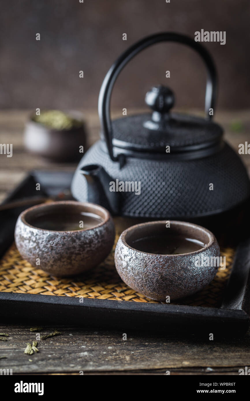 Still-life of japanese healthy green tea in a small cups and teapot ...