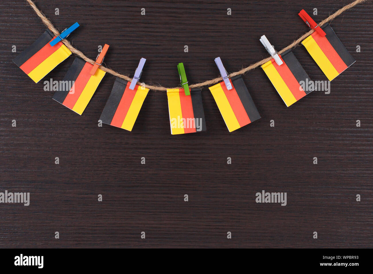 Flags of Germany hanging on clothesline attached with wooden ...