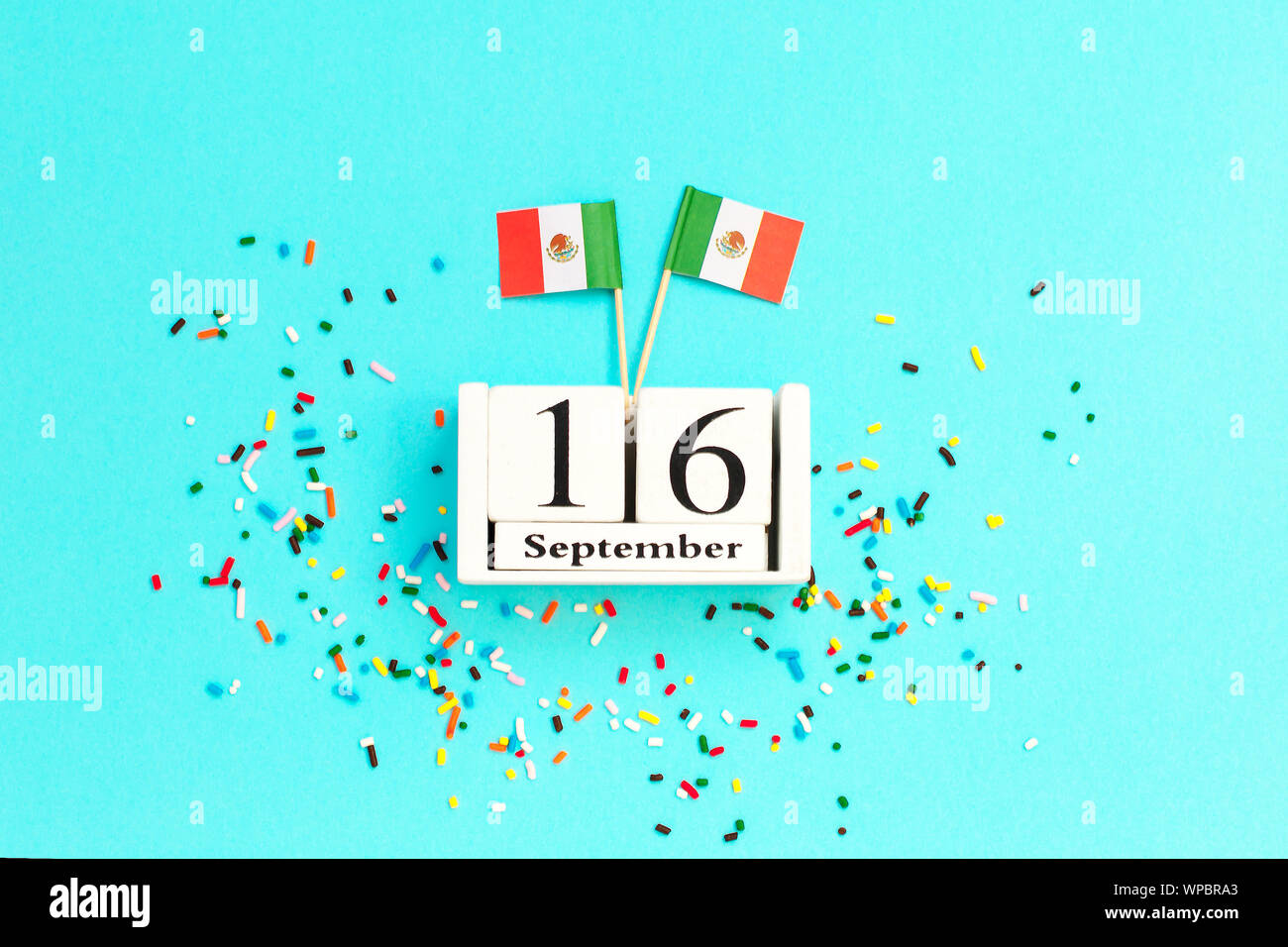SEPTEMBER 16 Wooden calendar and confetti on blue background. Concept ...