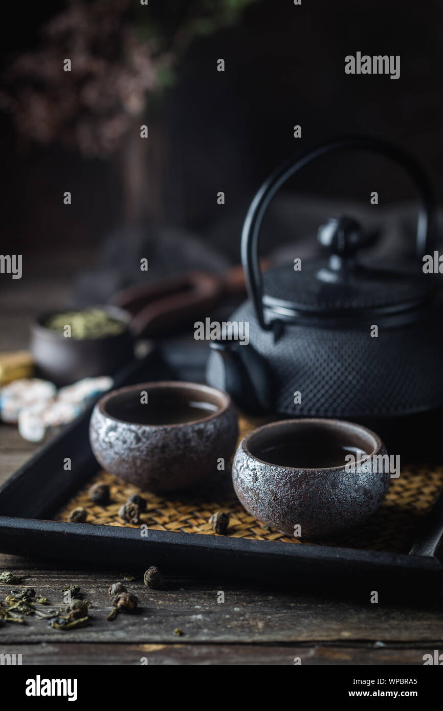 Still-life of japanese healthy green tea in a small cups and teapot ...