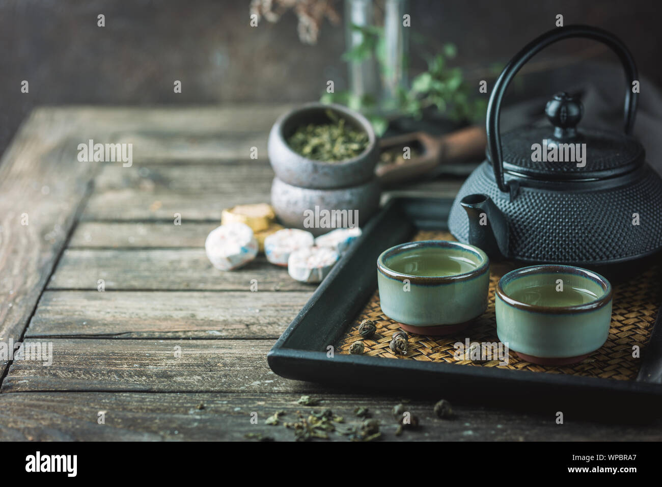 Still-life of japanese healthy green tea in a small cups and teapot ...
