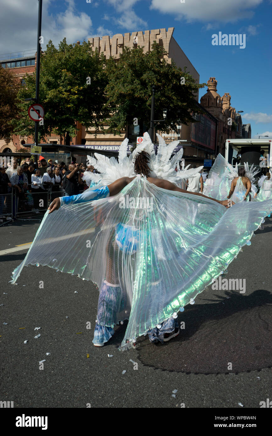 Dancers and musicians on parade enjoying Hackney Carnival in the streets of Hackney, London ...