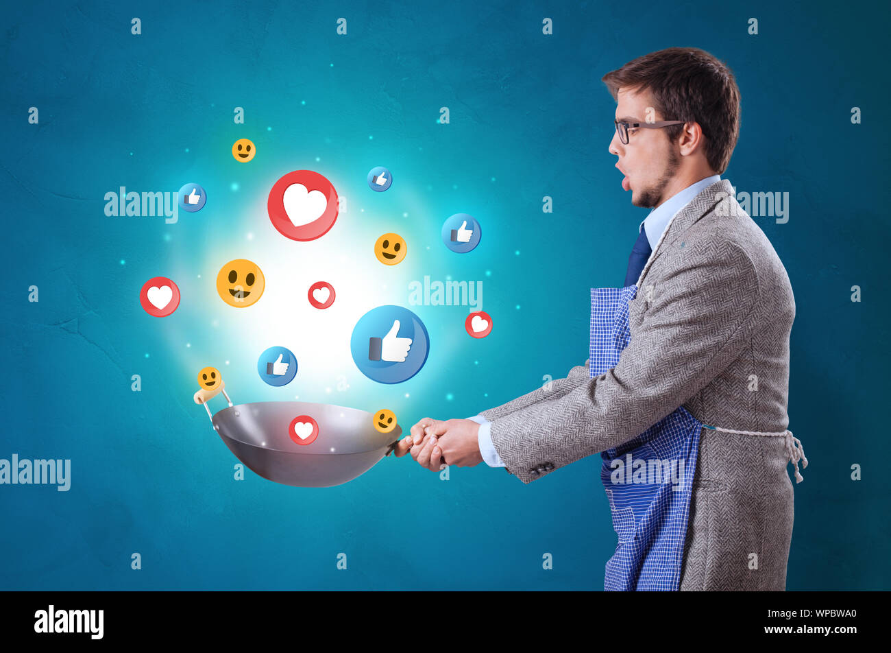 Young happy person cooking social media concept in wok Stock Photo - Alamy