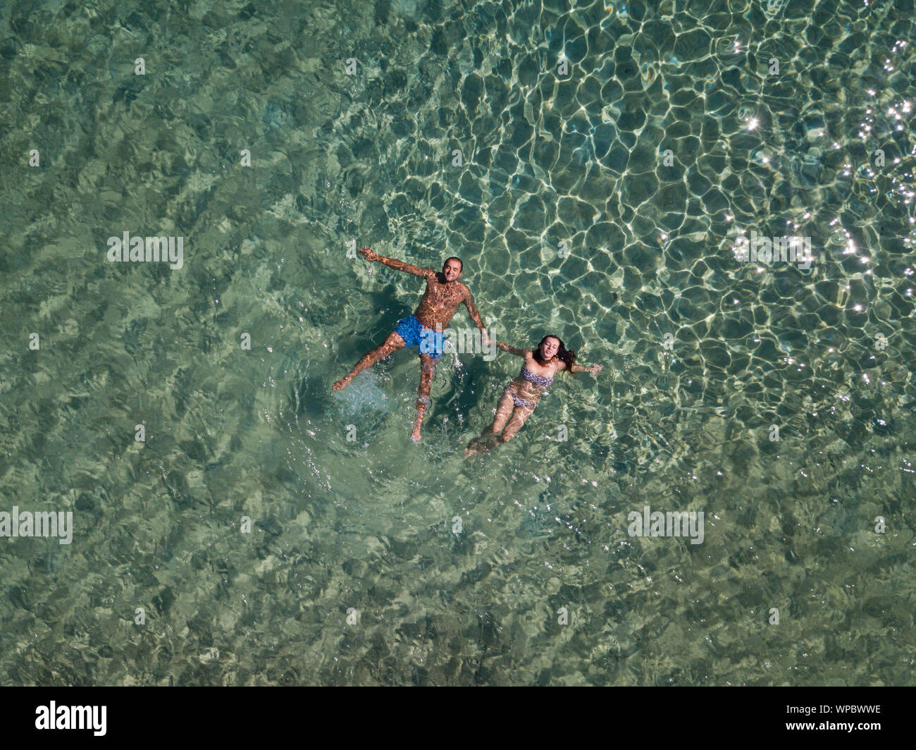 Cute couple floating in the sea aerial Stock Photo - Alamy