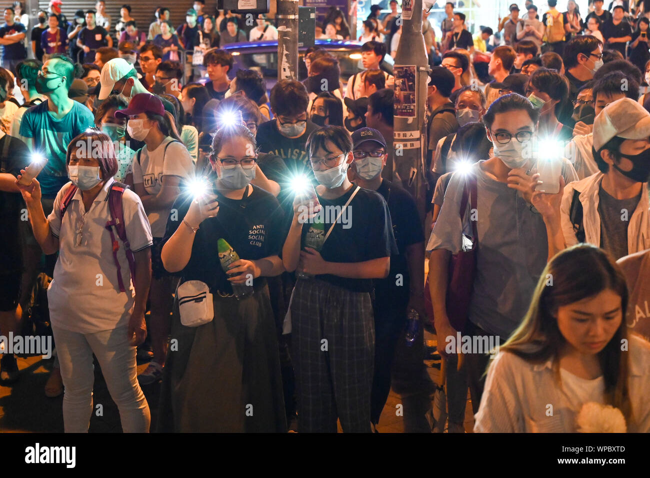 Hong Kong, China. 7th Sep 2019. A crowd shines cell phone flashlights ...