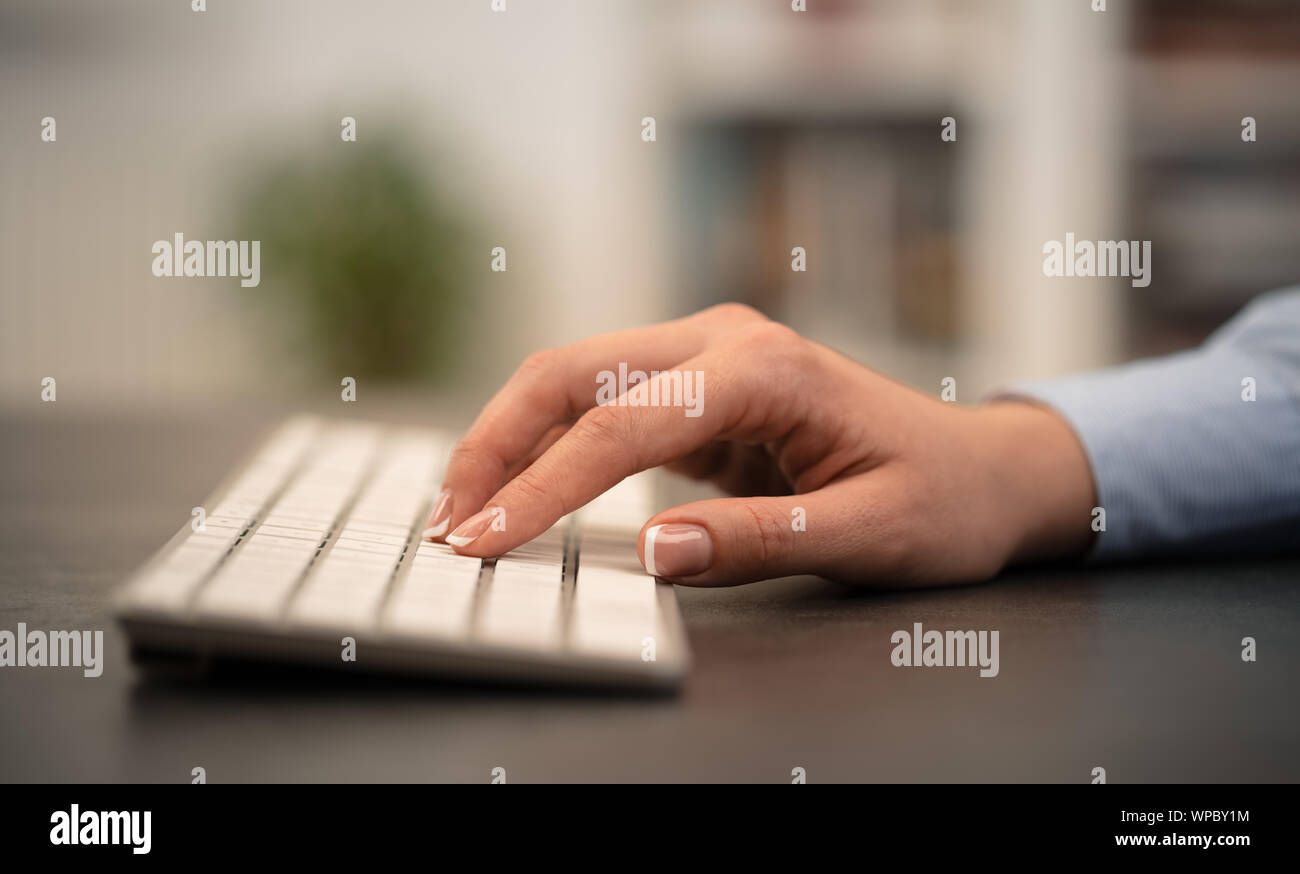 Hand typing on keyboard with office concept Stock Photo - Alamy