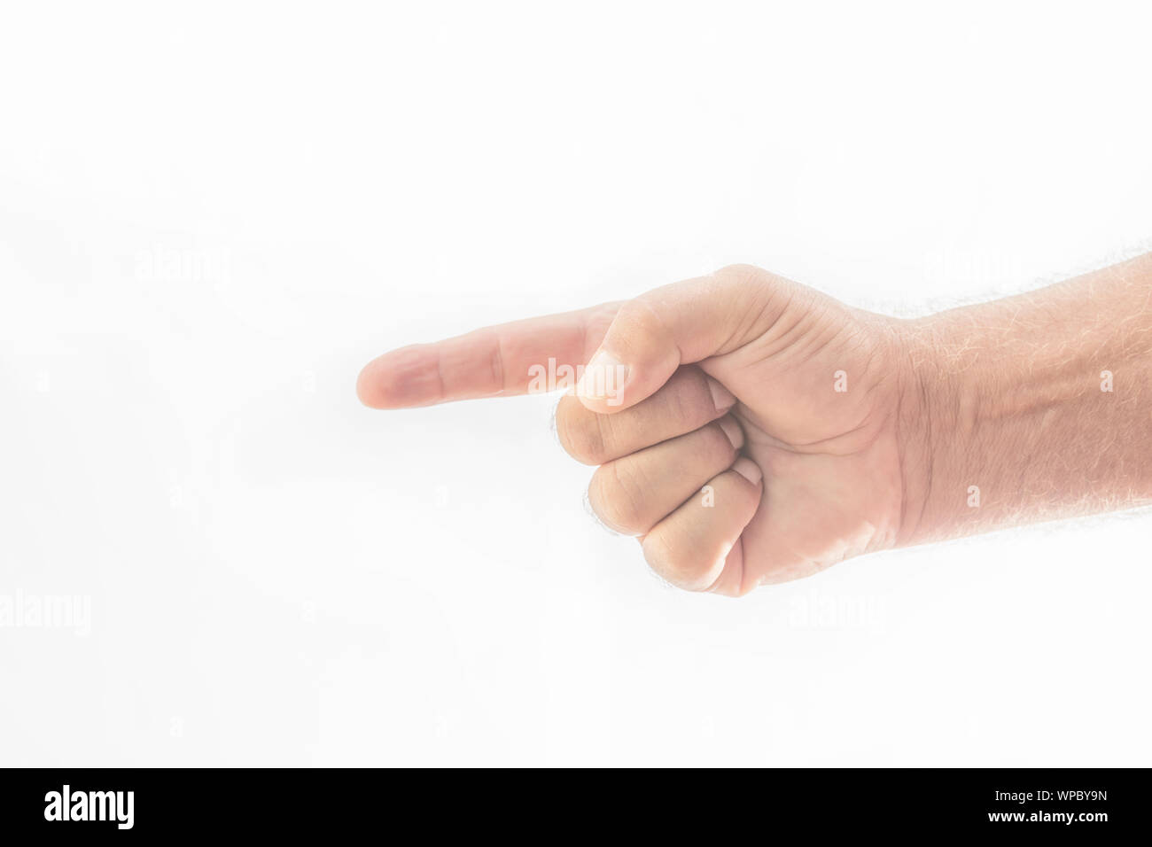 Detail of a man's hand pointing with the index finger on a white ...