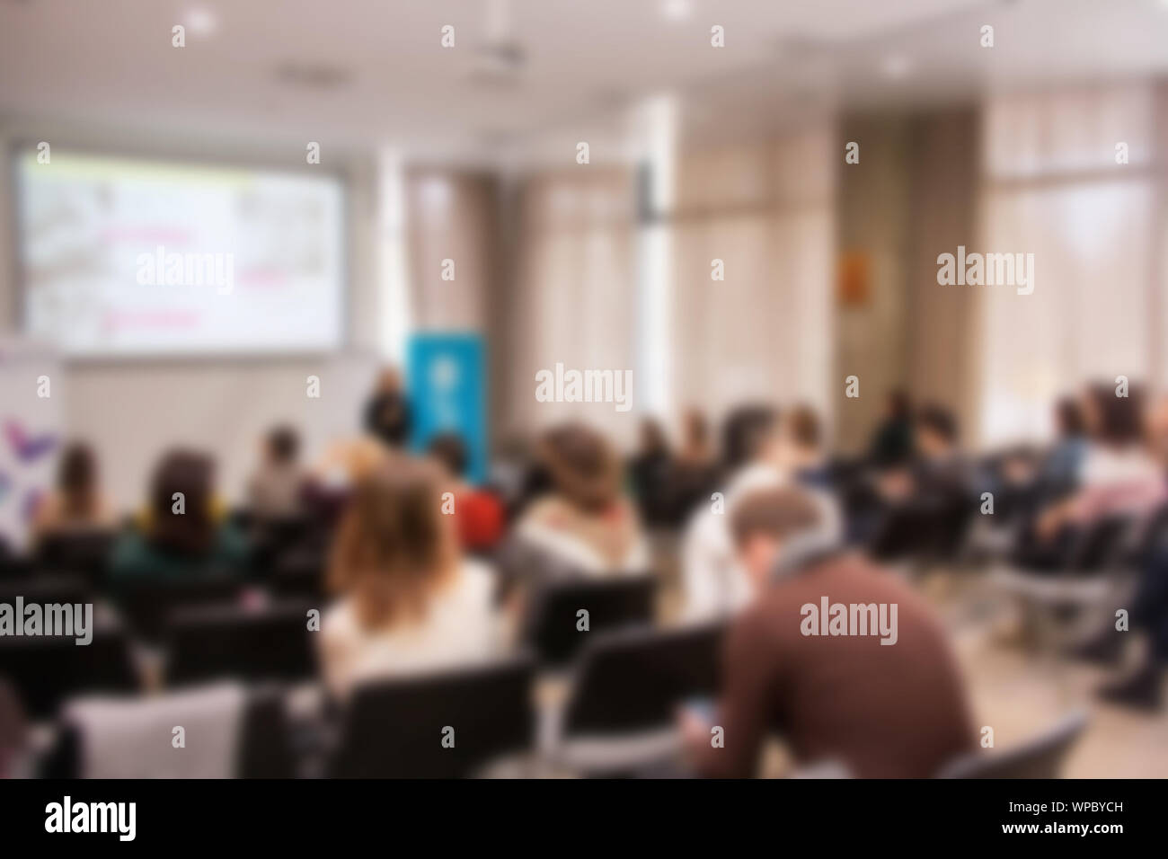Blurred business seminar meeting in the conference hall. Defocused ...