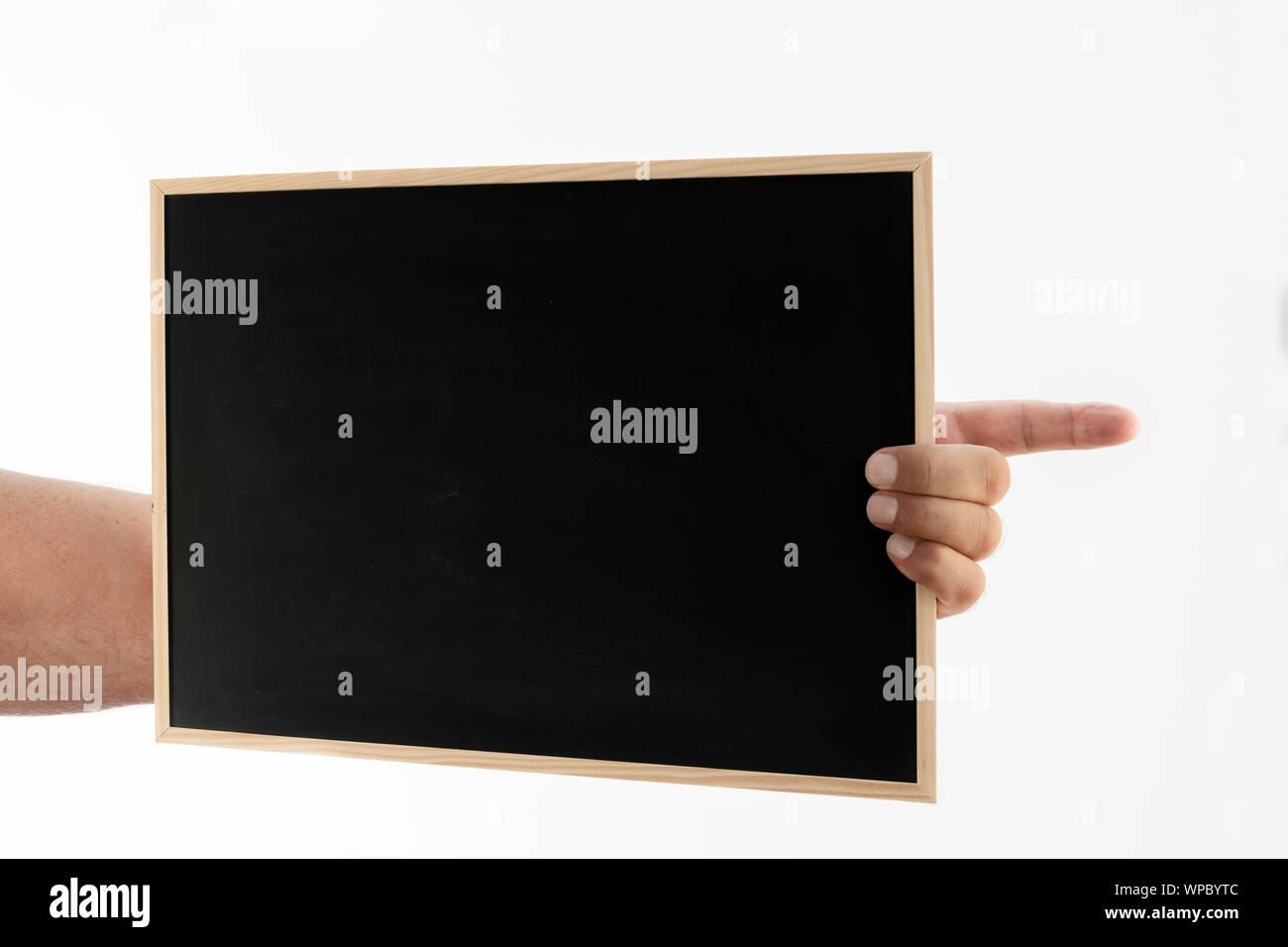 A blackboard with a wooden edge held by a man's hand on a white ...