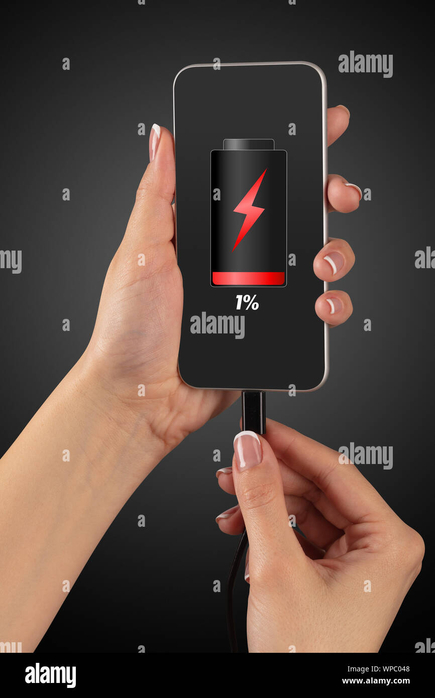 Elegant hand charging cellphone with low battery Stock Photo - Alamy