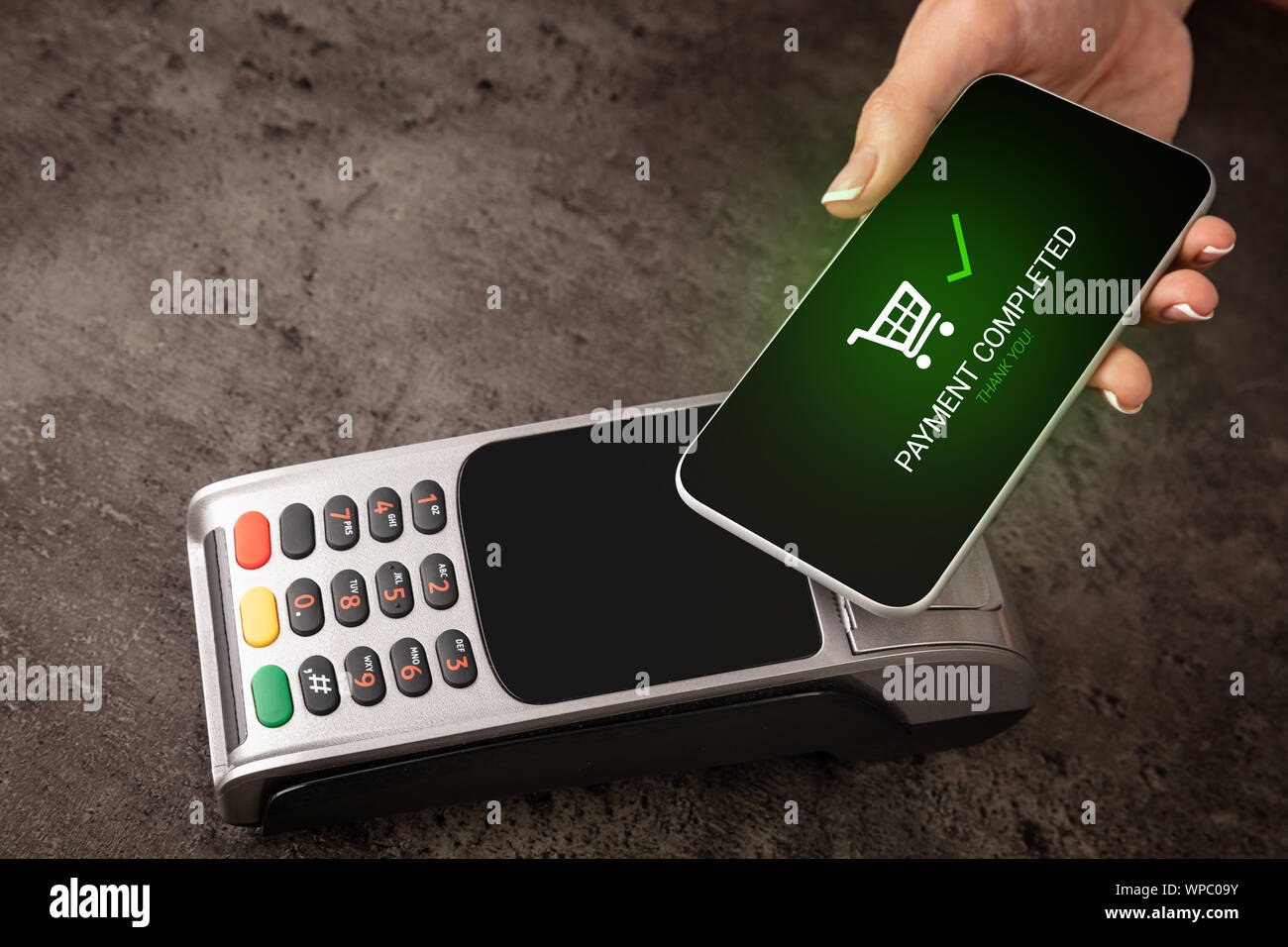 Mobile payment accepted on terminal Stock Photo - Alamy