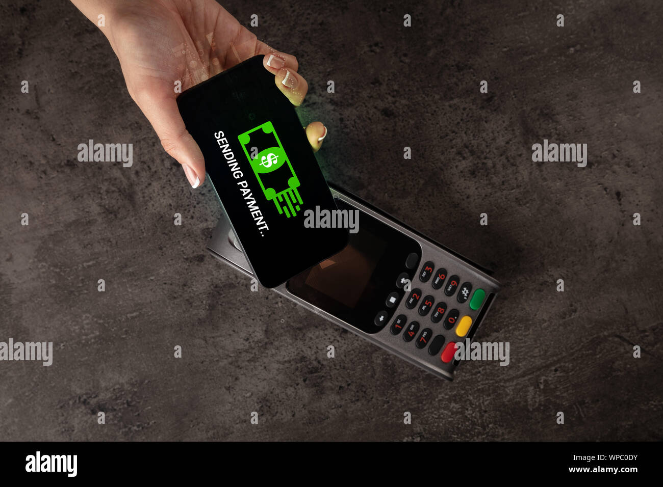 Hand paying with digital currency from smartphone Stock Photo - Alamy