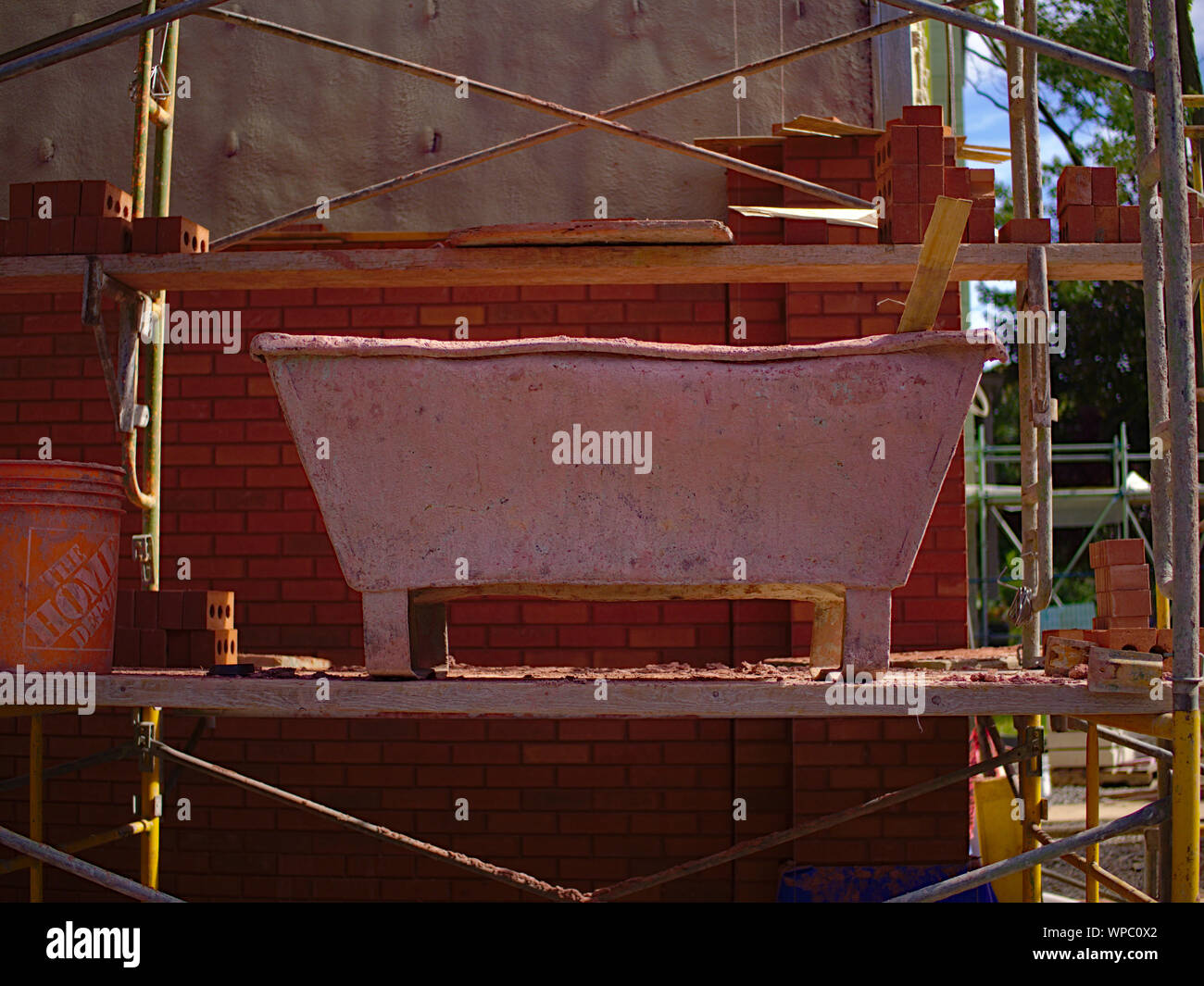 On a building site, a bathtub for mixing mortar for the brickwork outer ...