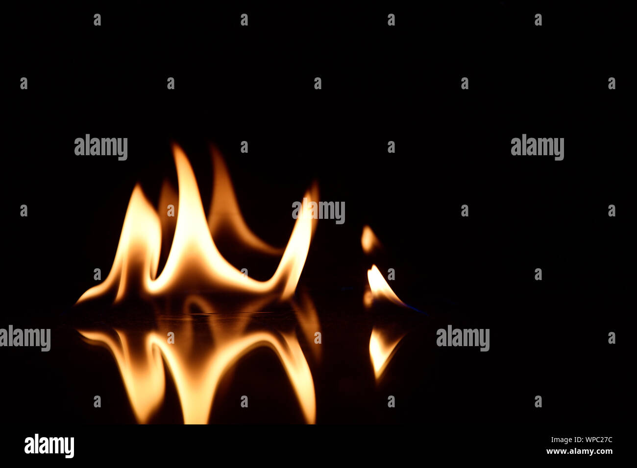 fire and reflection on black background Stock Photo - Alamy