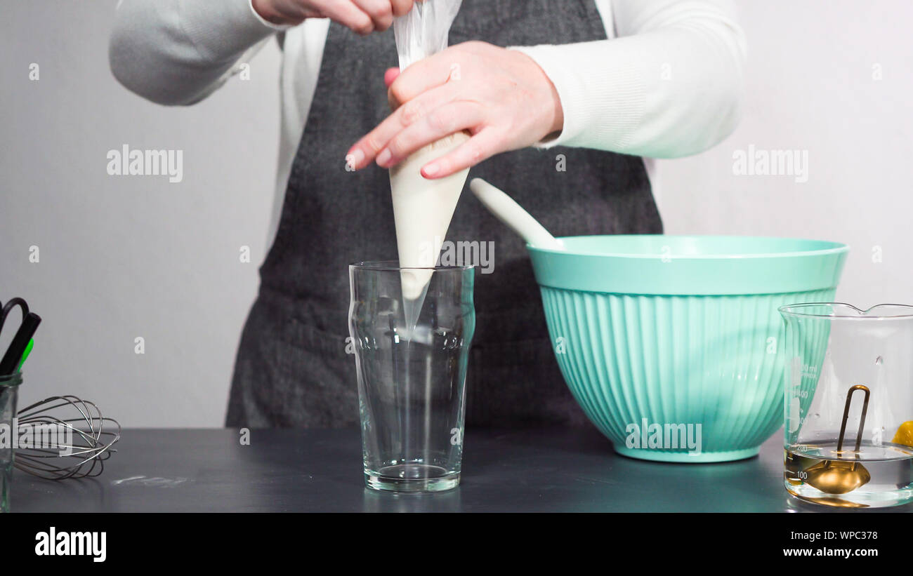 Step by step. Pouring royal icing into the piping bag to decorate sugar ...