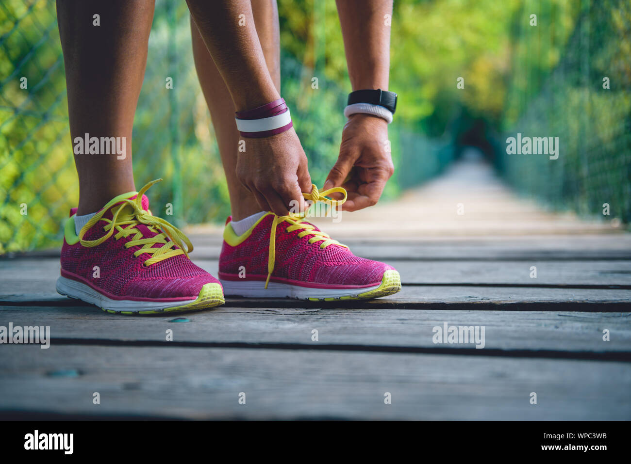 Women tying sports shoes Stock Photo - Alamy