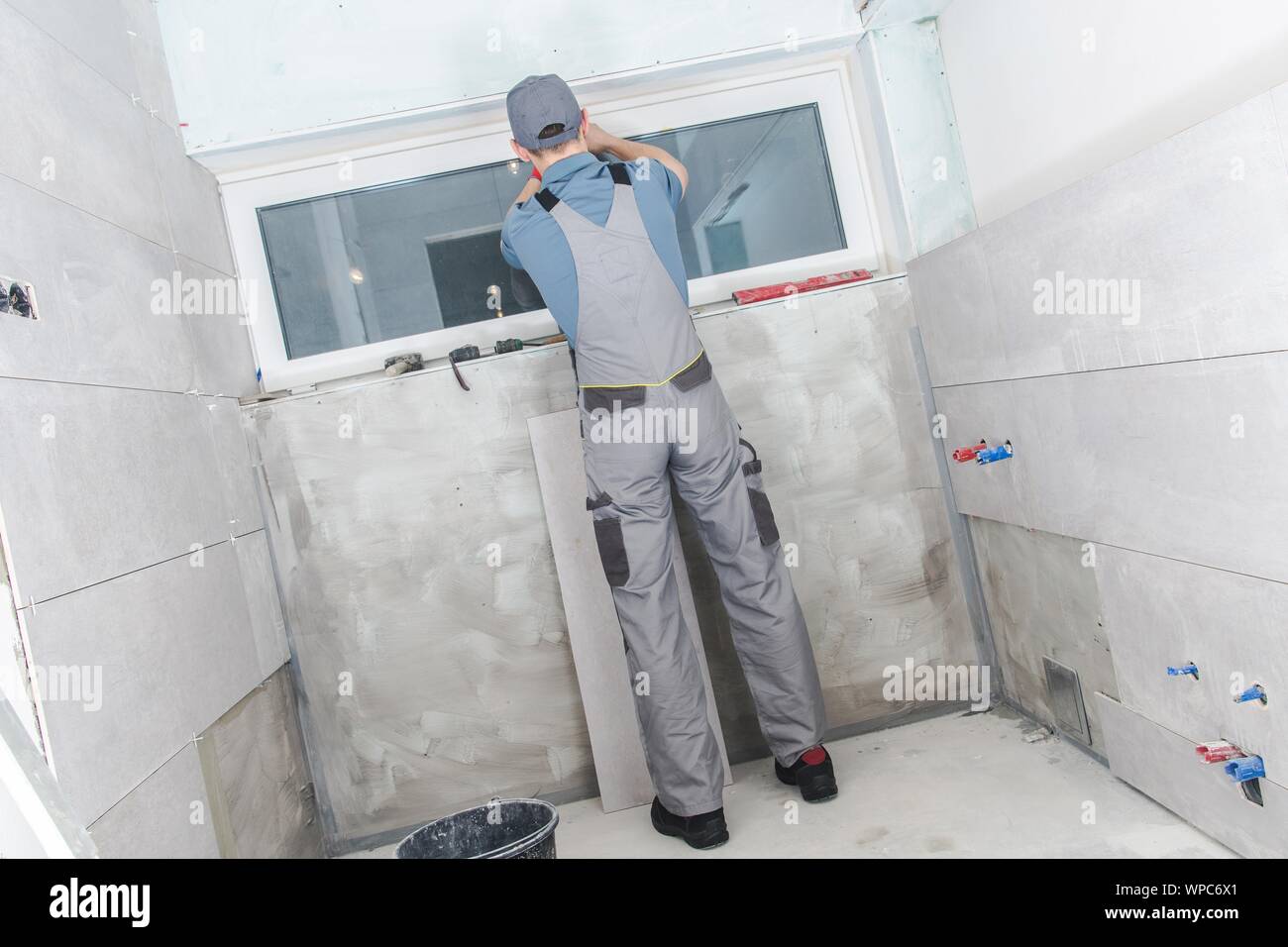 Bathroom Remodeling Job. Caucasian Construction Worker Installing New ...