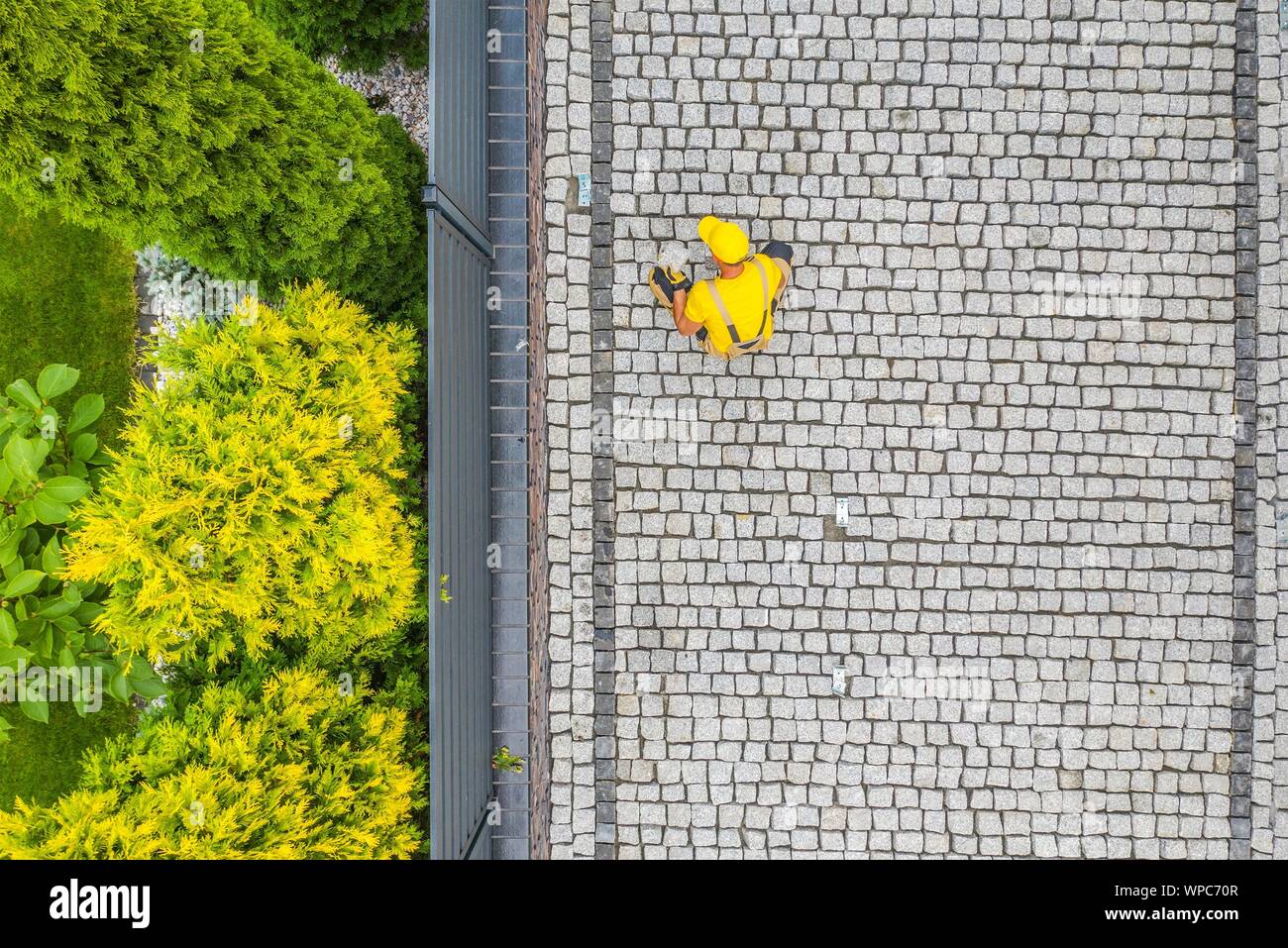 Residential Bricks Driveway Building. Caucasian Construction Worker ...
