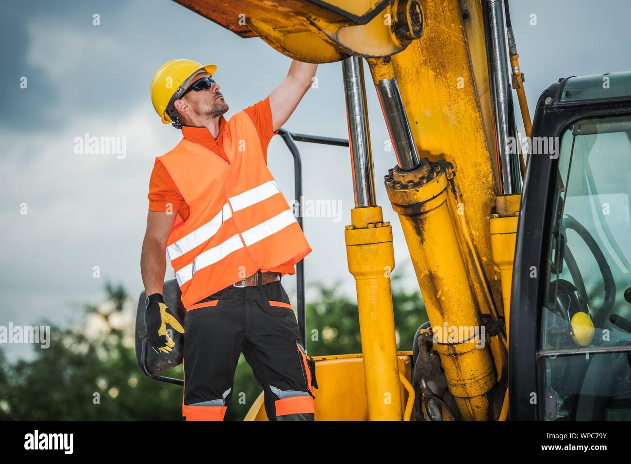 Modern Excavator Operator. Caucasian Construction Worker and the ...