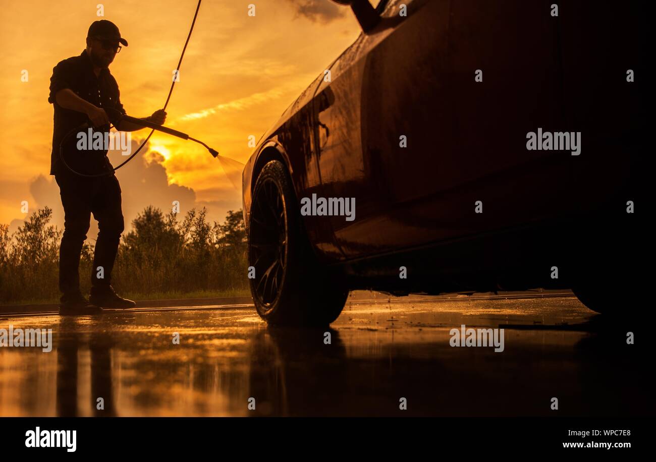 Sunset Car Washing. Caucasian Men in His 30s Cleaning His Modern Car ...