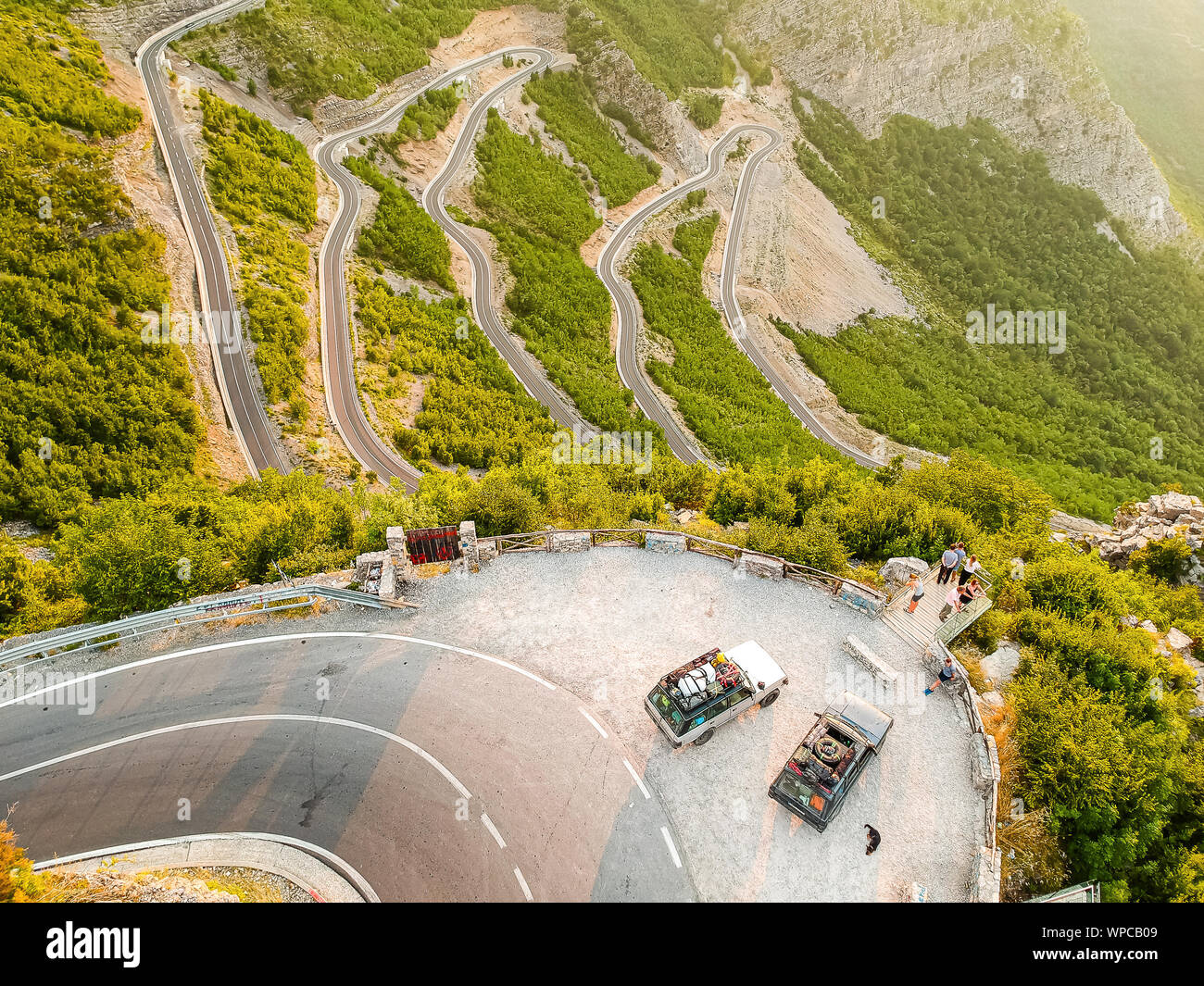 Off road cars on cliff by serpentine road in Albanian mountains near ...