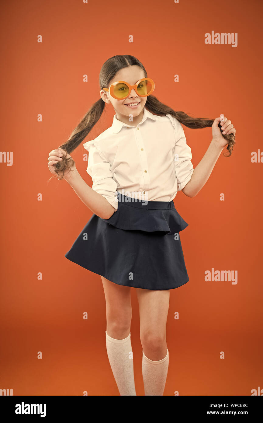 I am a girl and I am smart. Little smart schoolgirl on orange ...