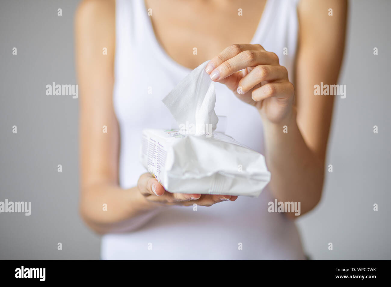 Wet wipes are universal an practical: woman take one wipe from big ...