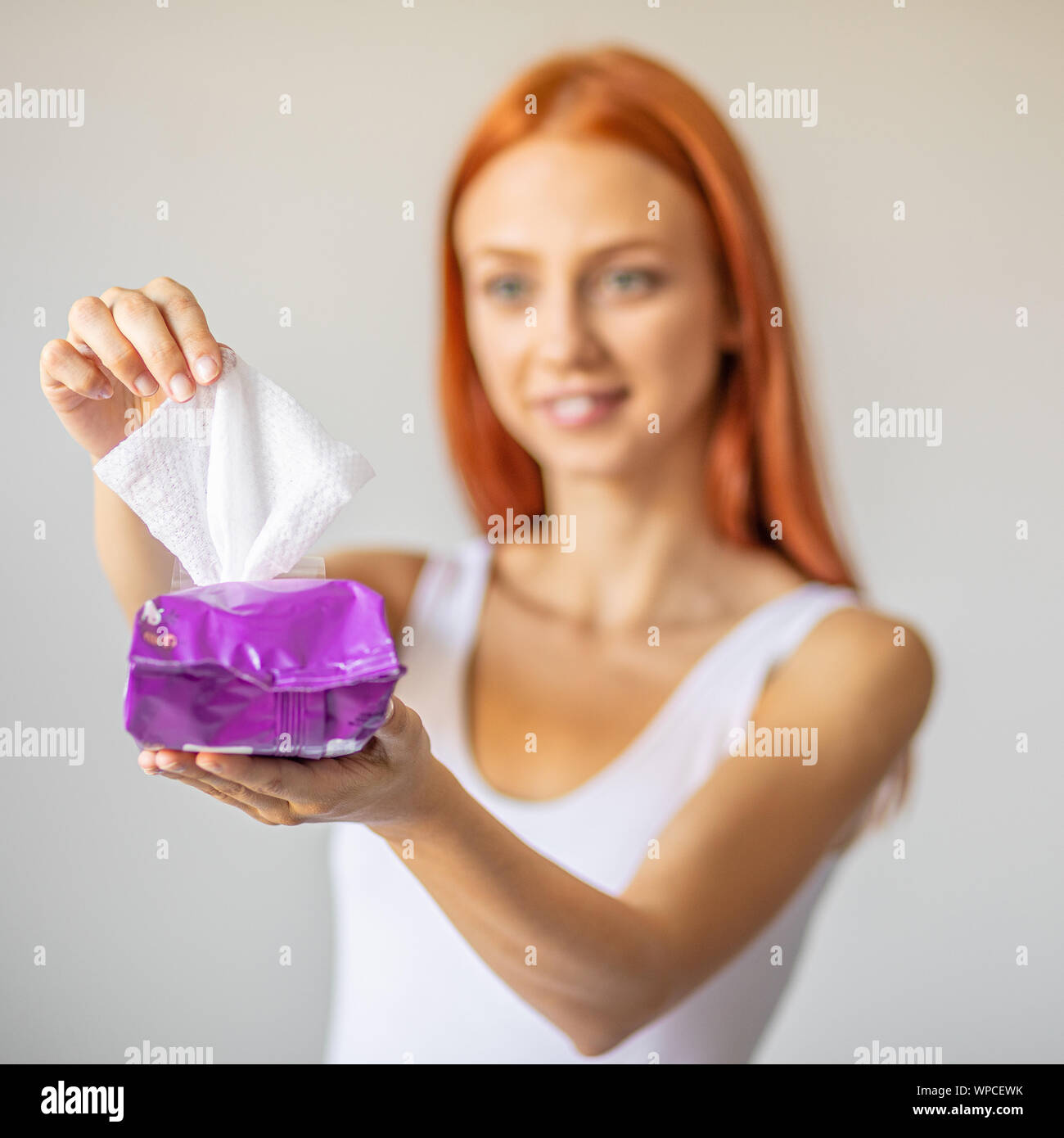 Wet wipes are universal an practical: red-hair women take one wipe from ...