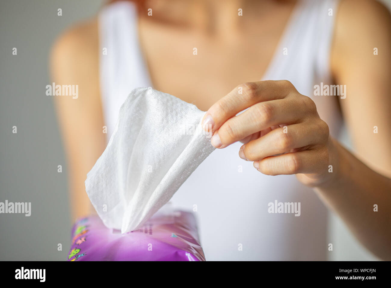 Wet wipes are universal an practical: woman take one wipe from big ...