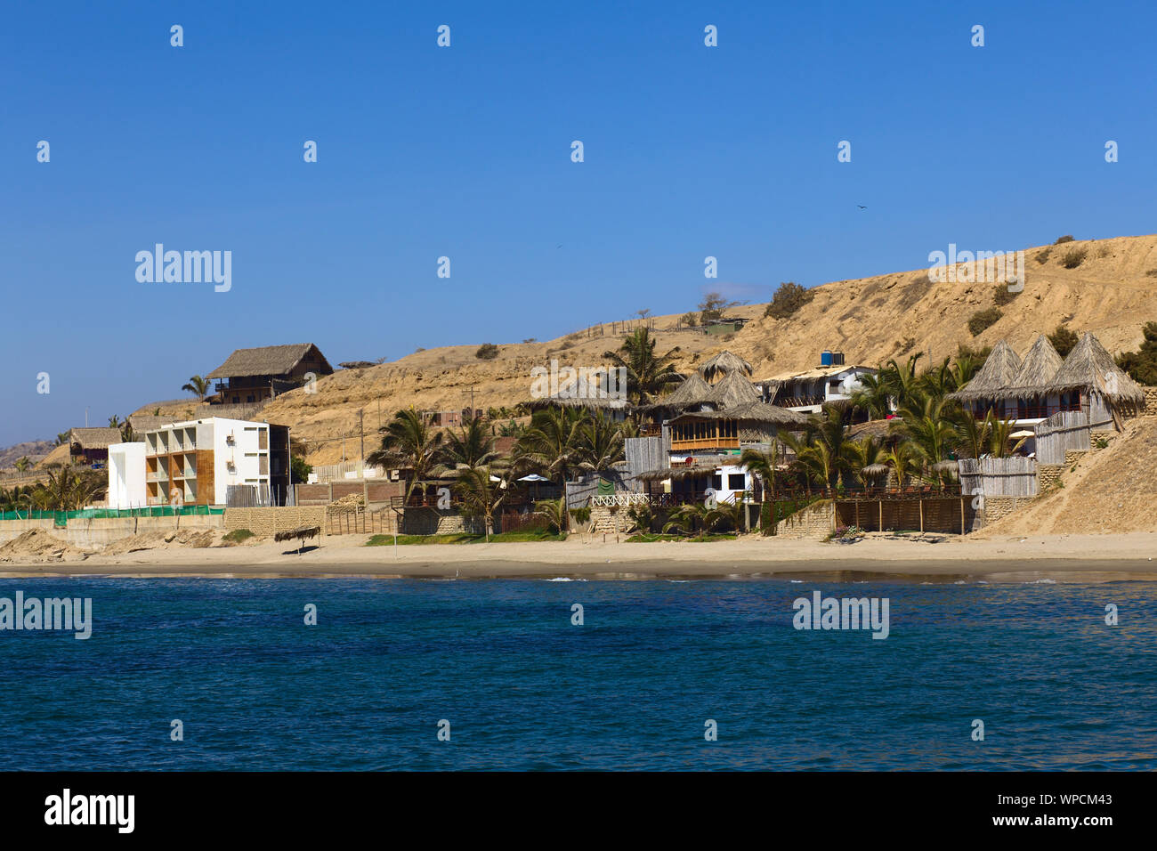 MANCORA, PERU - AUGUST 17, 2013: Thatched roof accomodation with palm ...