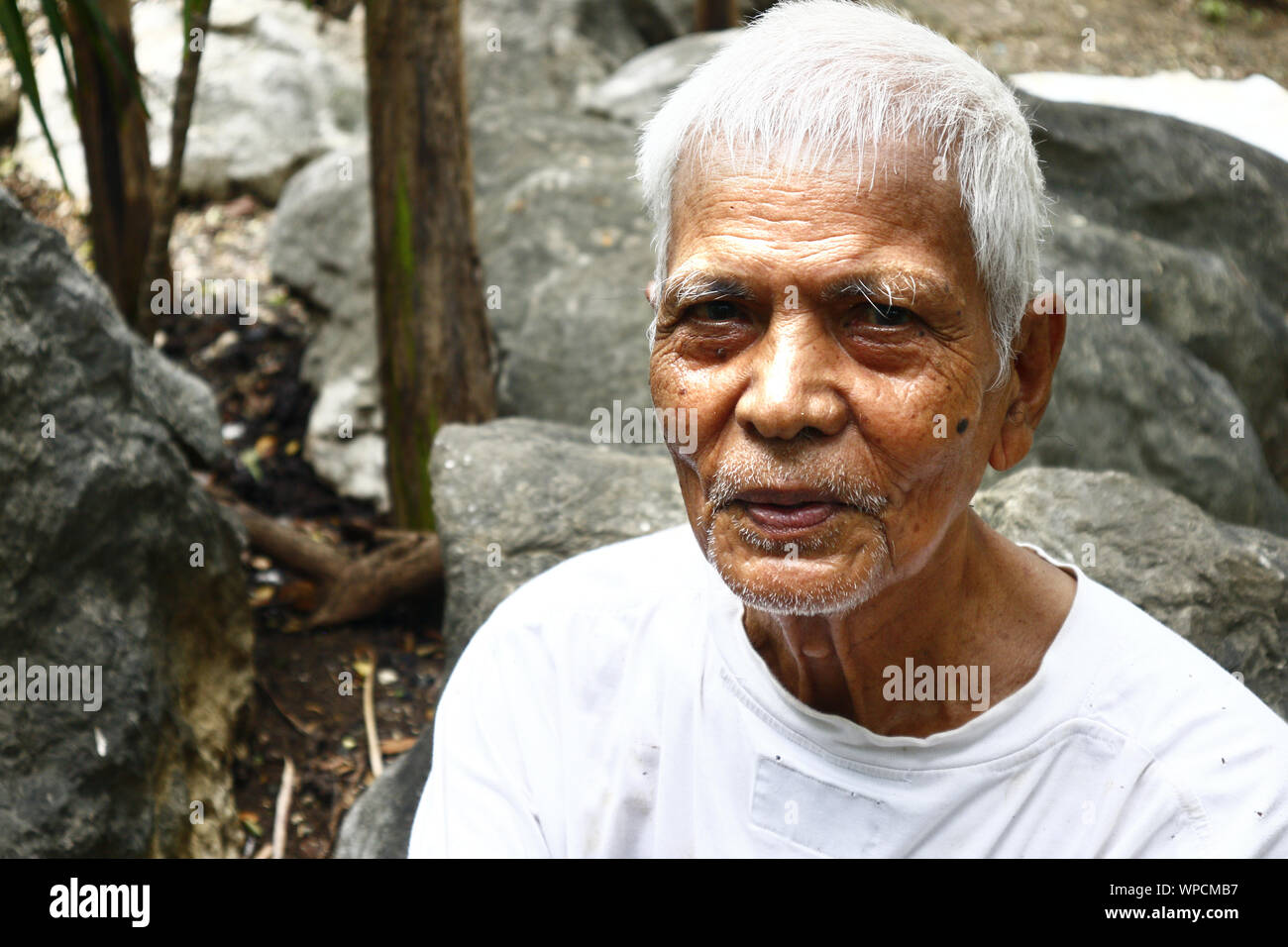 ANTIPOLO CITY, PHILIPPINES - SEPTEMBER 6, 2019: Adult Filipino man sits ...