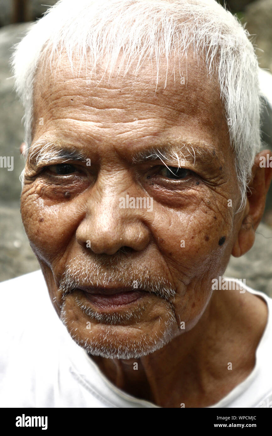 ANTIPOLO CITY, PHILIPPINES - SEPTEMBER 6, 2019: Adult Filipino man sits ...