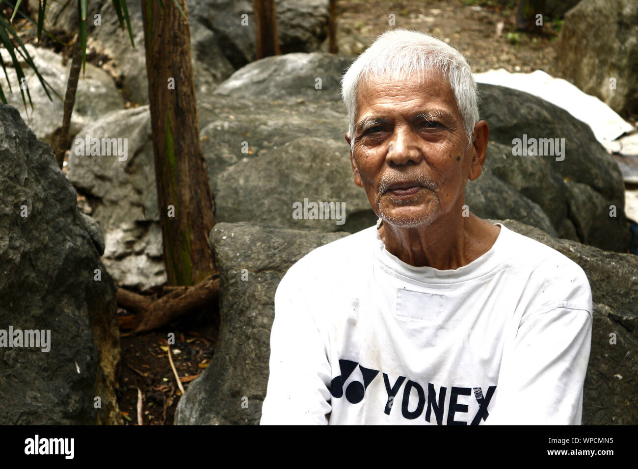 ANTIPOLO CITY, PHILIPPINES - SEPTEMBER 6, 2019: Adult Filipino man sits ...