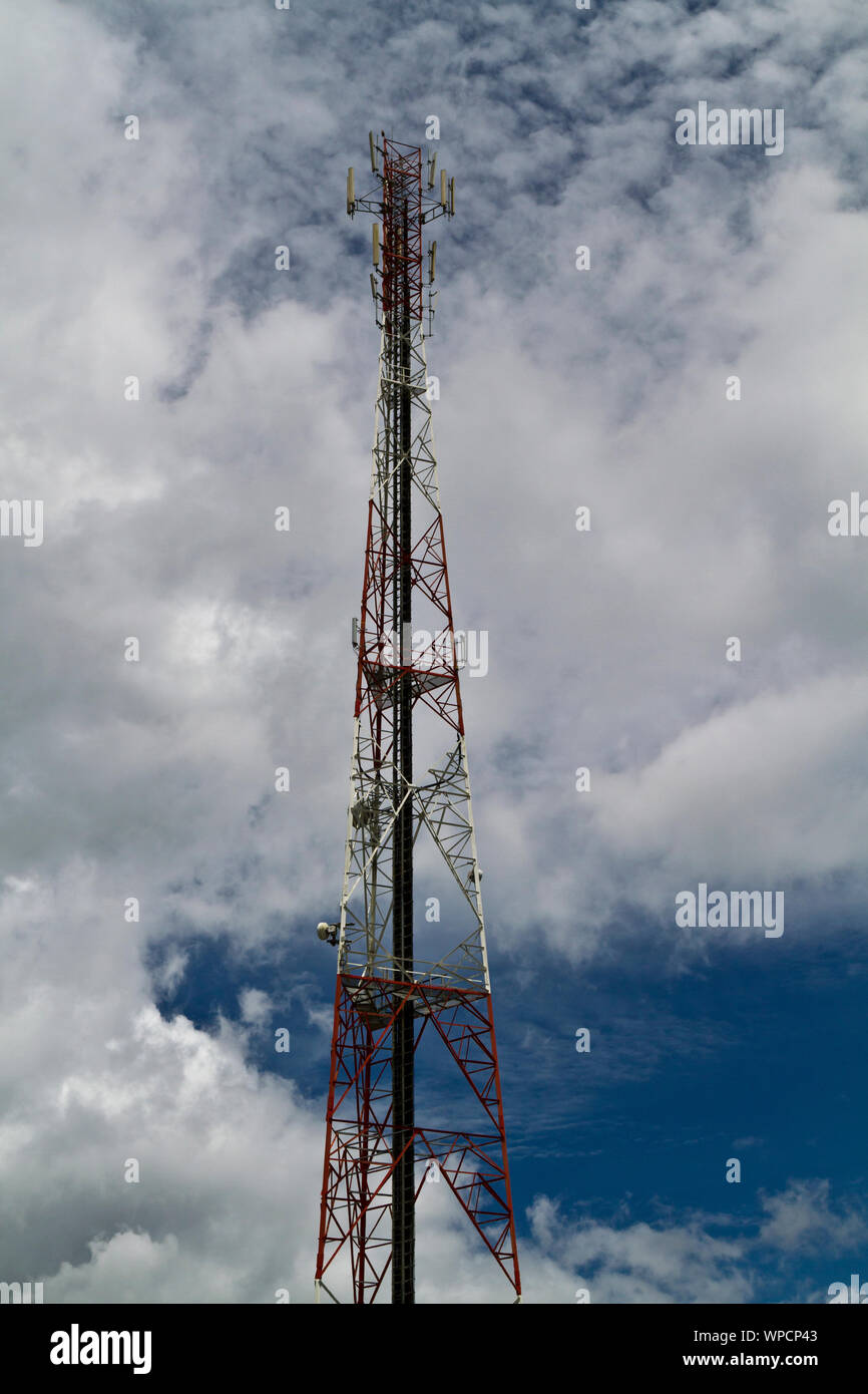 View of a radio tower against the sky with white cloud in portrait ...