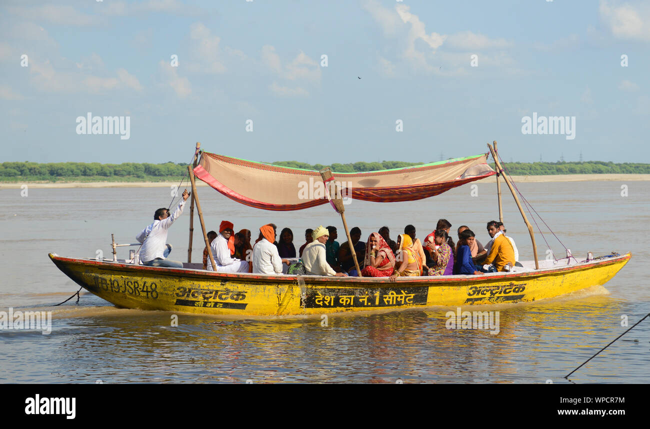 Pilgrims riding a boat on the Ganges river in Varanasi Stock Photo - Alamy