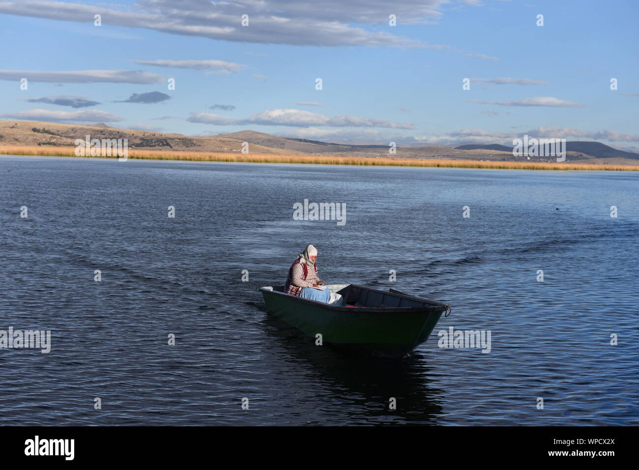 Puno, Peru. 8th Sep, 2019. An Uro woman on board a motor boat is seen ...