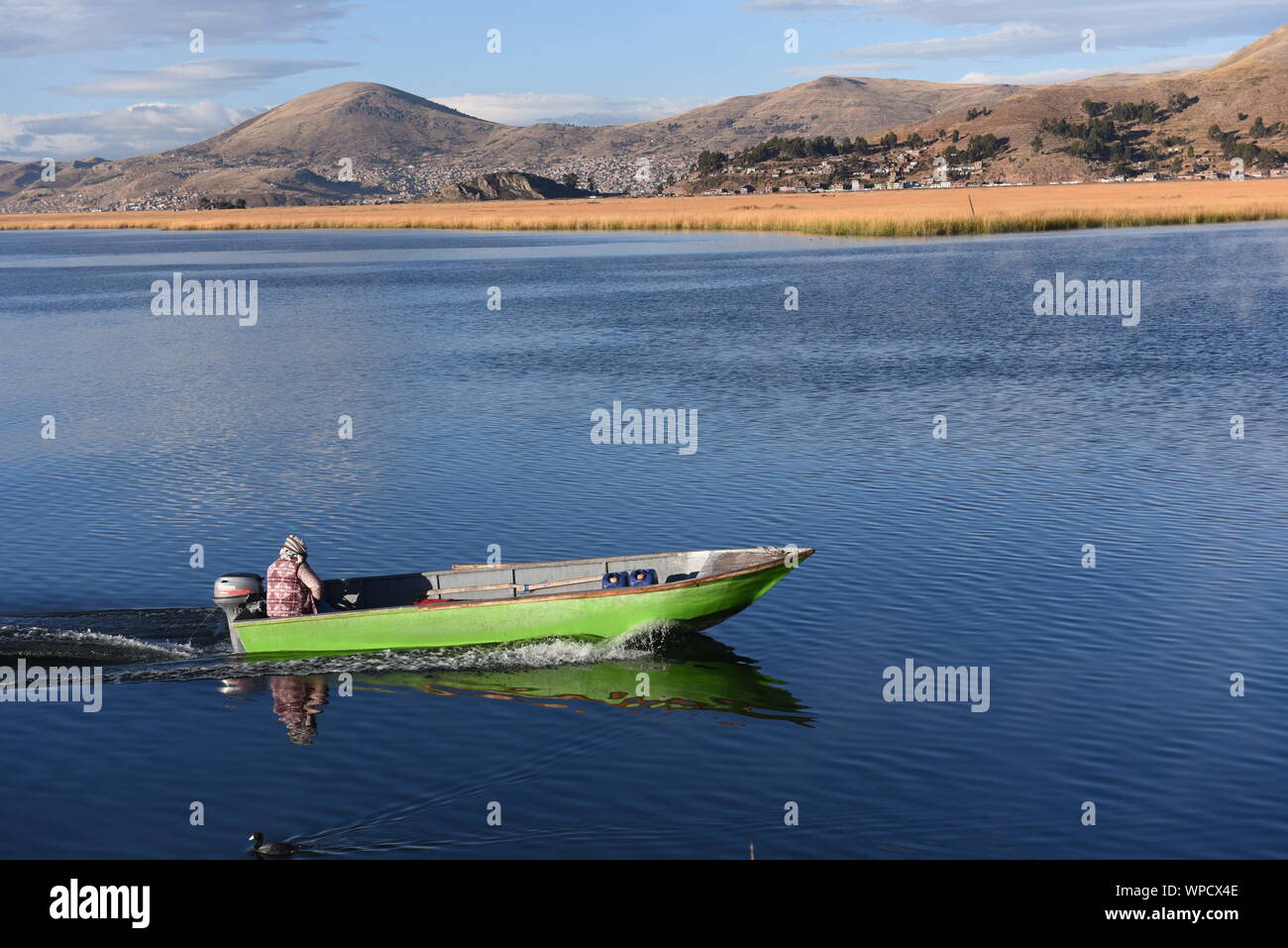 Puno, Peru. 8th Sep, 2019. An Uro woman on board a motor boat is seen ...