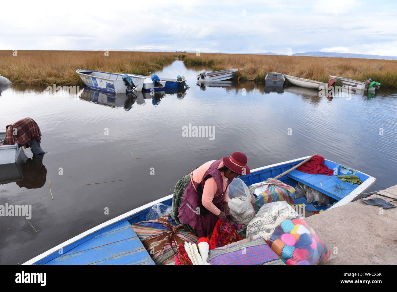 Puno, Peru. 7th Sep, 2019. An Uro woman on board a motor boat is seen ...