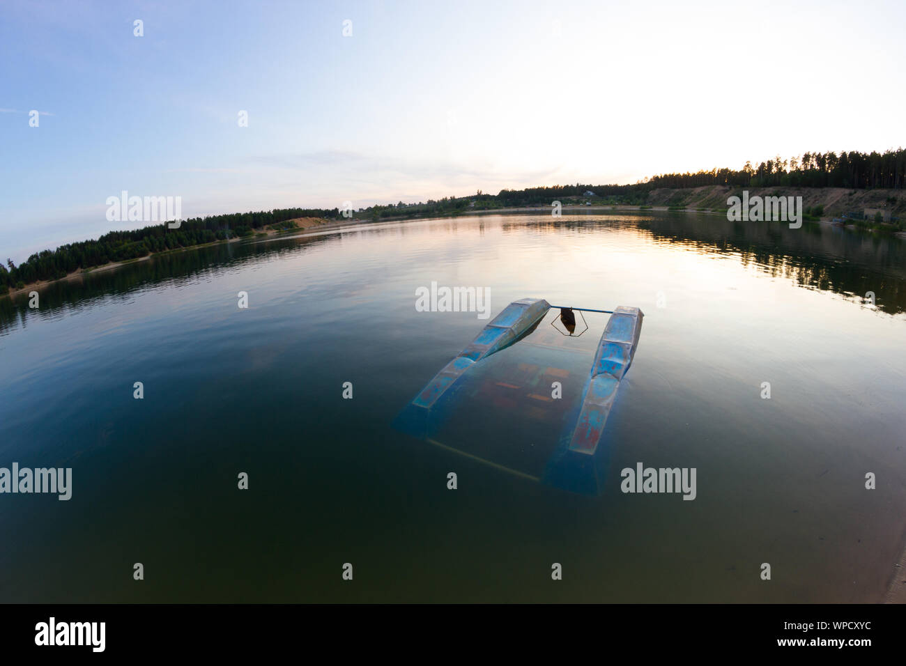 Sinking catamaran in lake. Old blue catamaran Stock Photo - Alamy