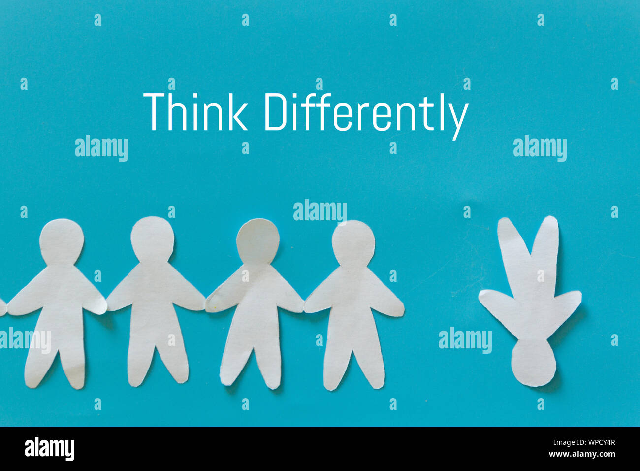 Think differently concept image. Paper people standing on their heads ...
