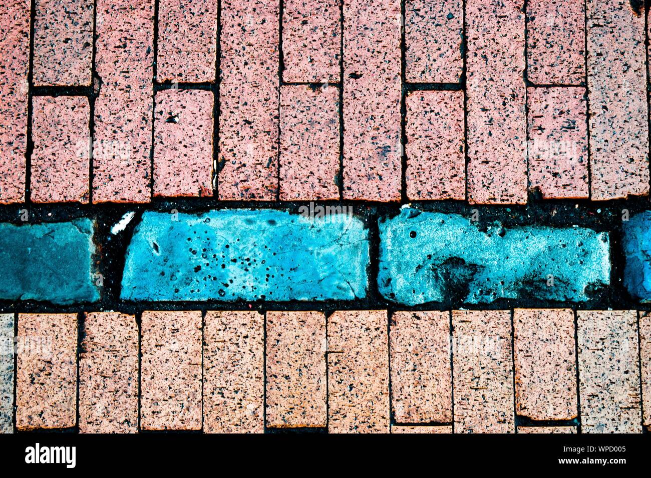 Closeup shot of blue bricks between brown bricks on the street for ...