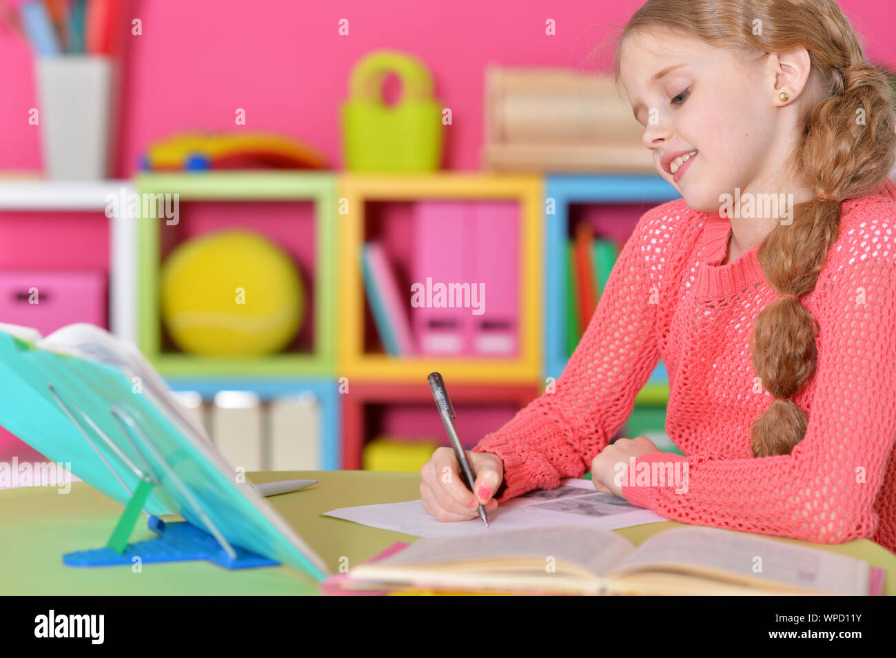 Portrait of cute schoolgirl doing homework at her room Stock Photo - Alamy