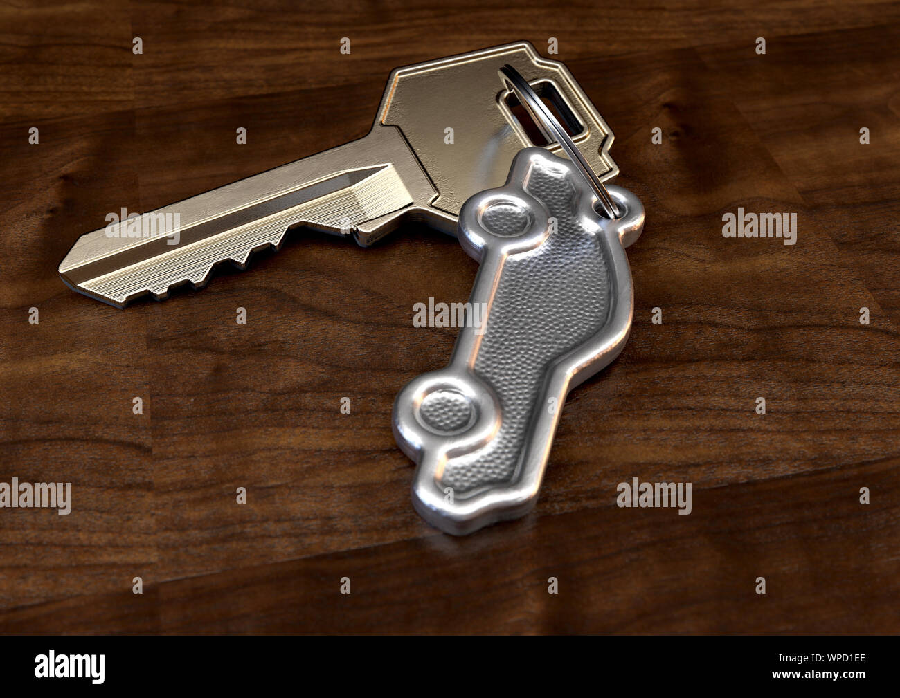 A brass key attached to a cast iron keyring in the shape of a car on an ...