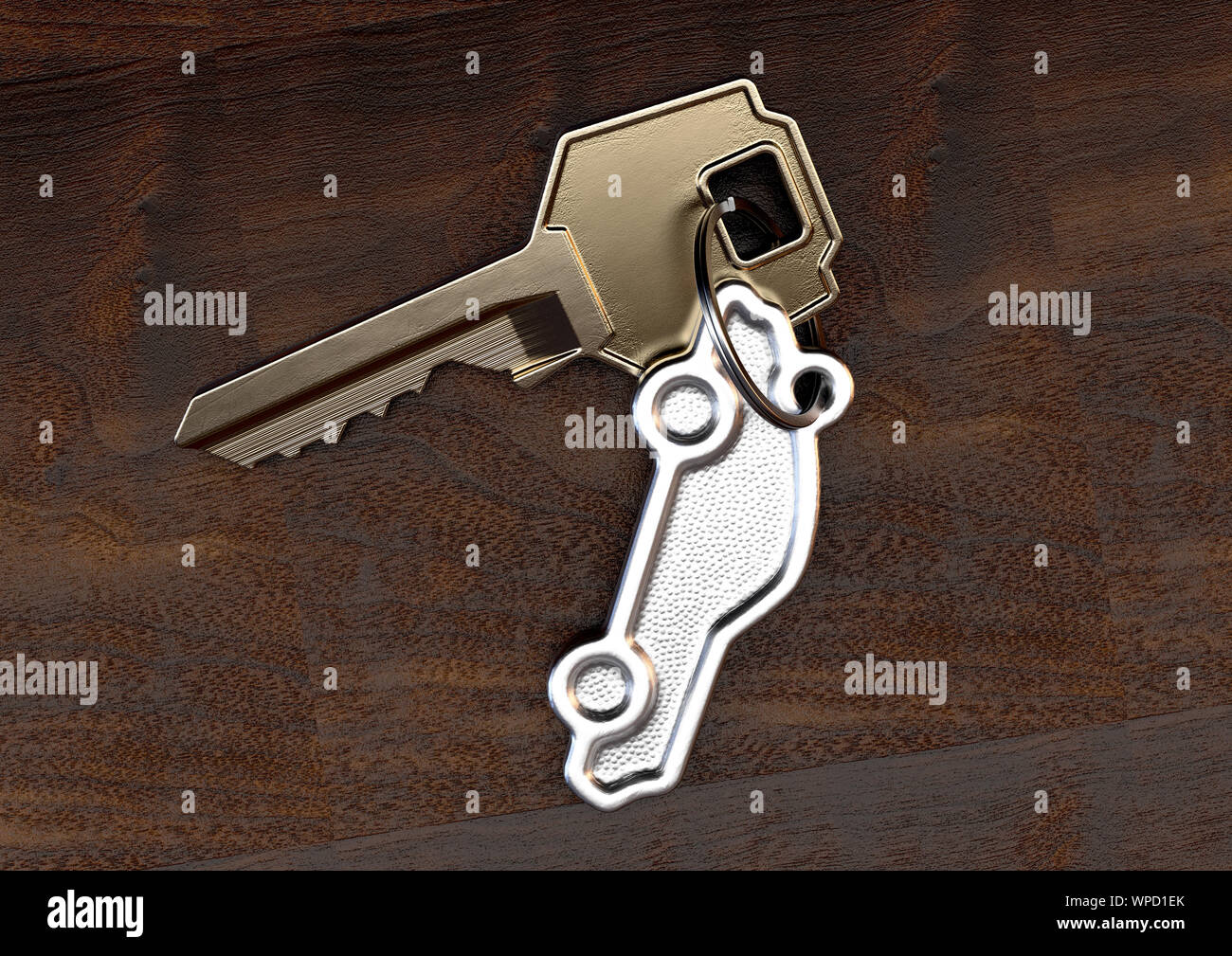 A brass key attached to a cast iron keyring in the shape of a car on an ...