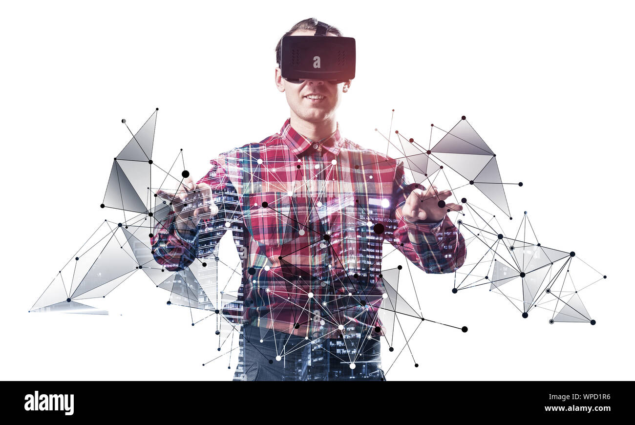 Young programmer wearing VR headset working with virtual model. New ...