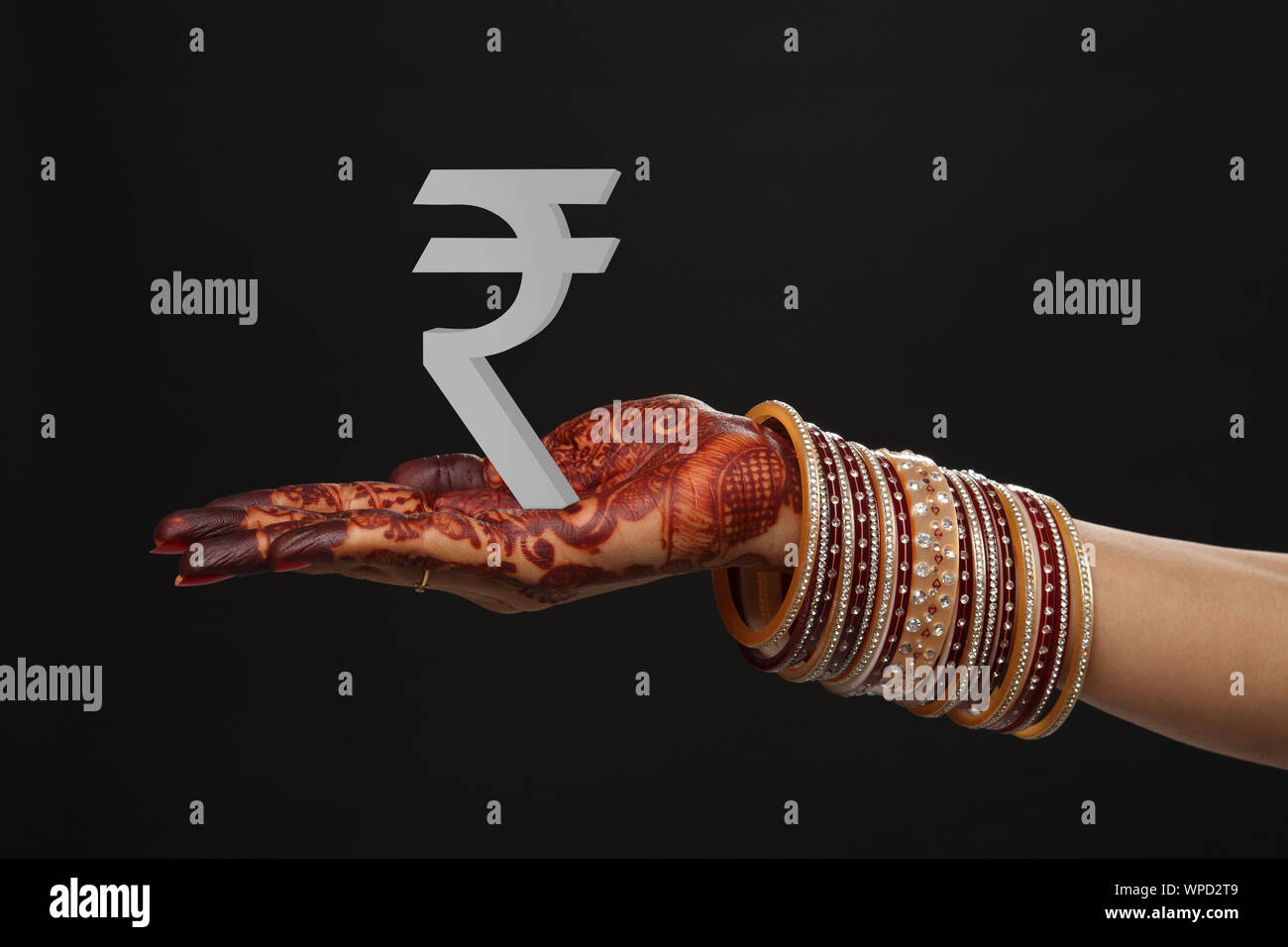 Bride woman's hand holding Indian rupee symbol Stock Photo - Alamy