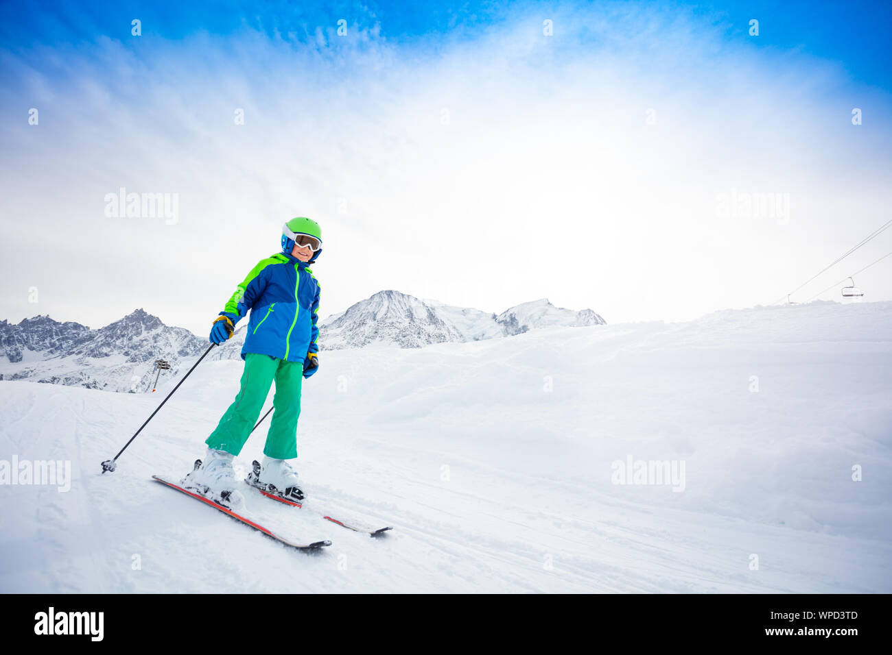 Happy skier sliding fast while skiing on slope Stock Photo - Alamy