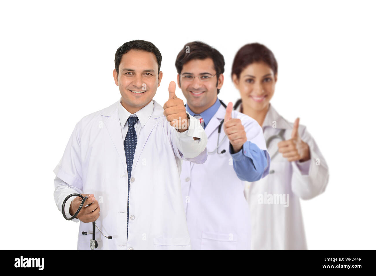 Confident group of doctors showing thumbs up sign Stock Photo - Alamy